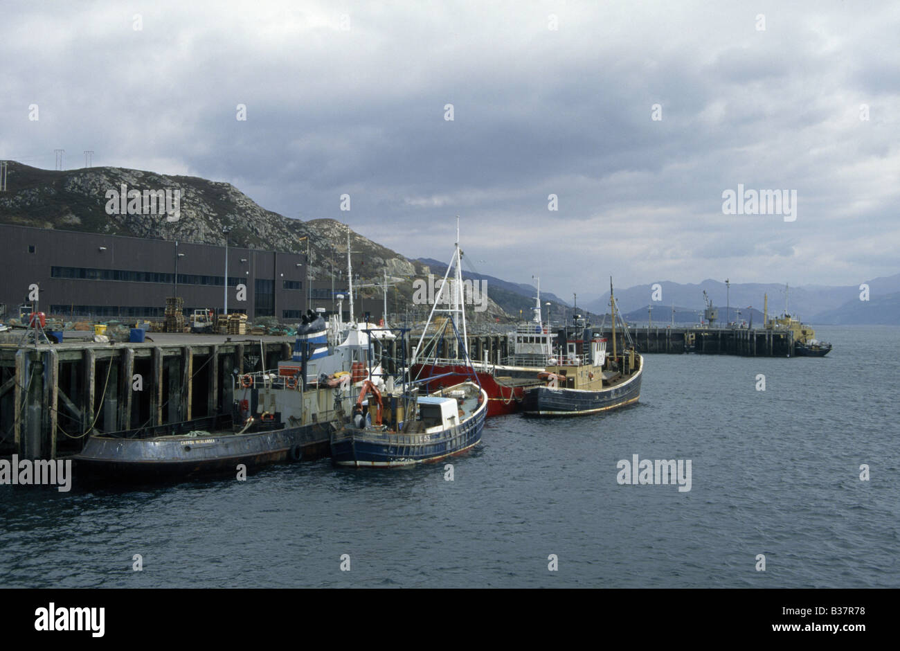 Harbour Four fishing boats with masts and winches Quay Fishboxes ...
