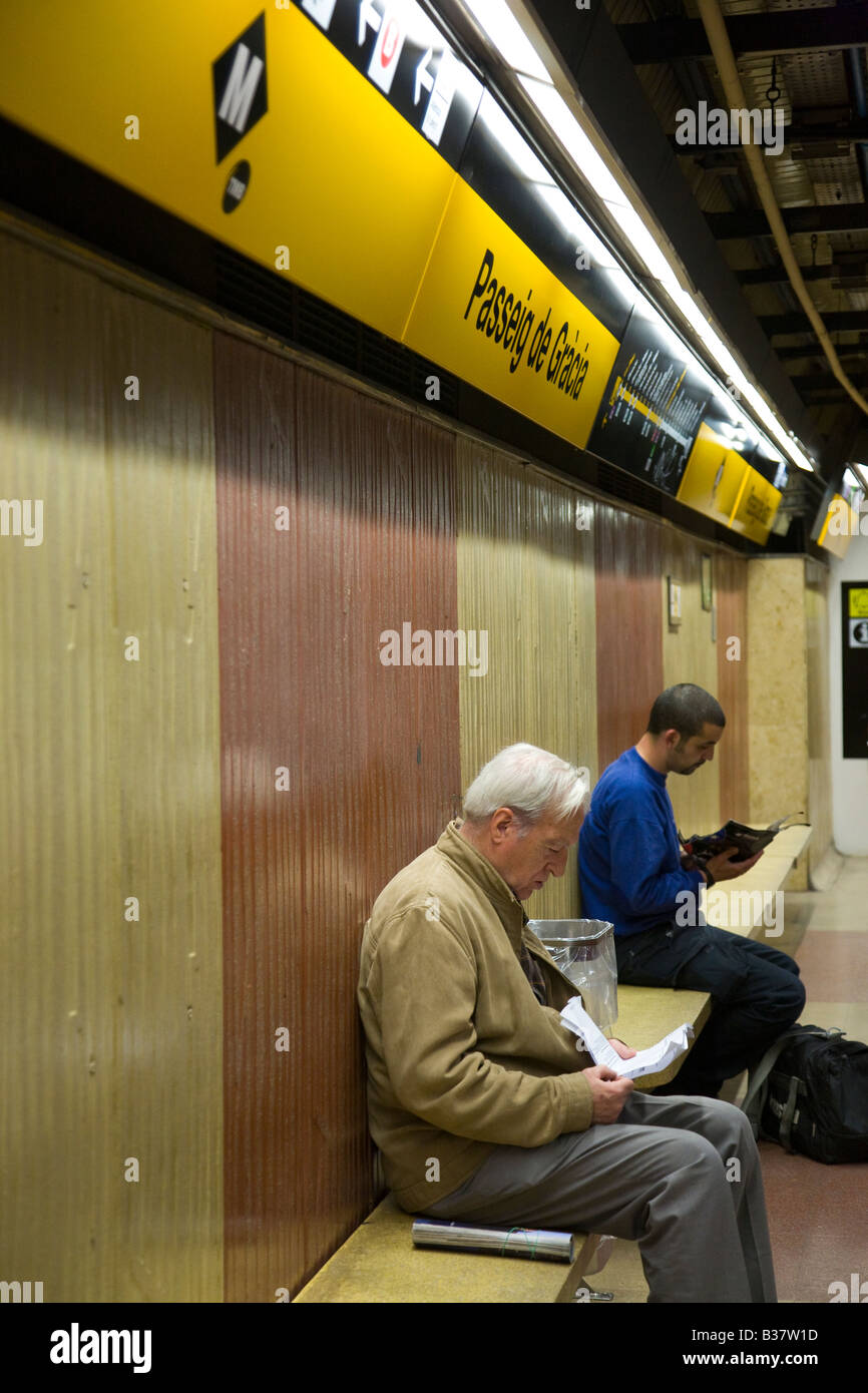 SPAIN Barcelona Passengers wait on bench under sign for Passeig de ...