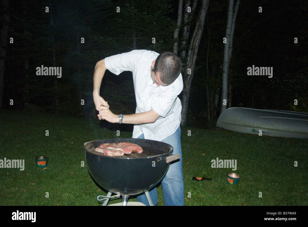 Man cooking barbecue Stock Photo - Alamy