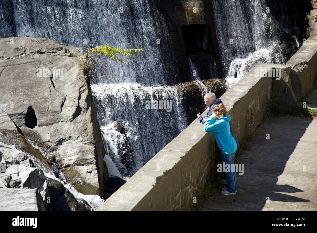 Father and daughter looking at waterfall Stock Photo - Alamy