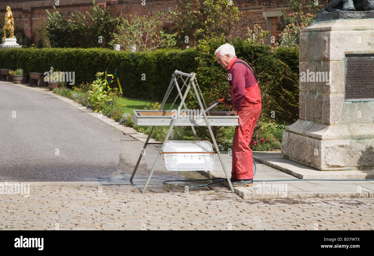 A street demonstrator demonstrating archaeological sieving in ...