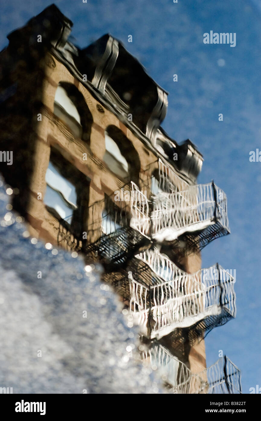 Building reflected in a puddle of water Stock Photo - Alamy