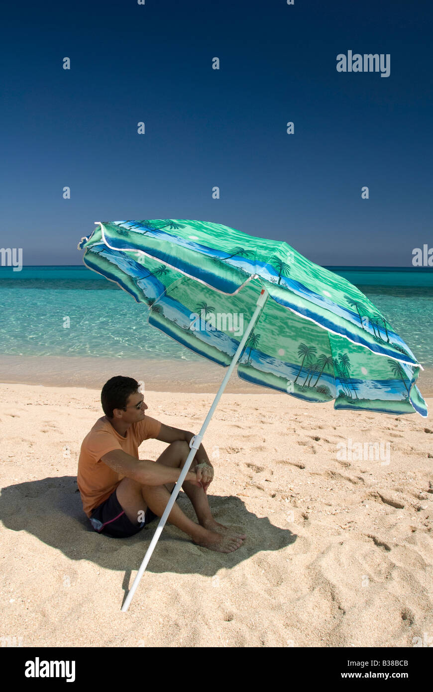 People sitting under beach umbrellas hi-res stock photography and ...