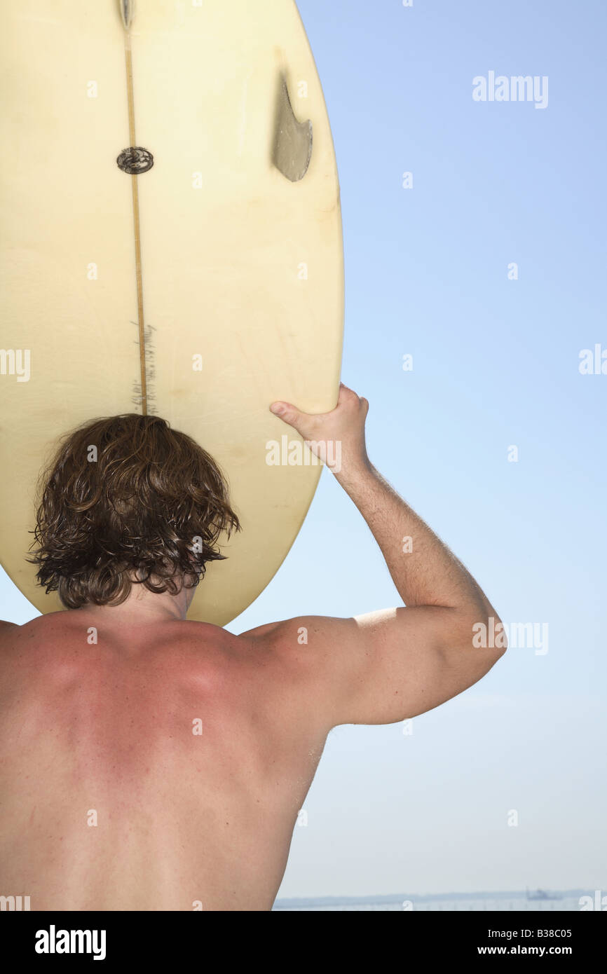 man carrying surfboard Stock Photo - Alamy