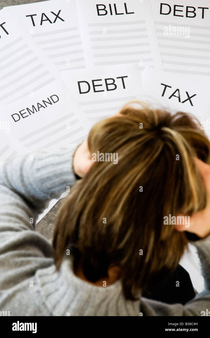 Woman with head in hands worrying about household debt and bills Stock ...