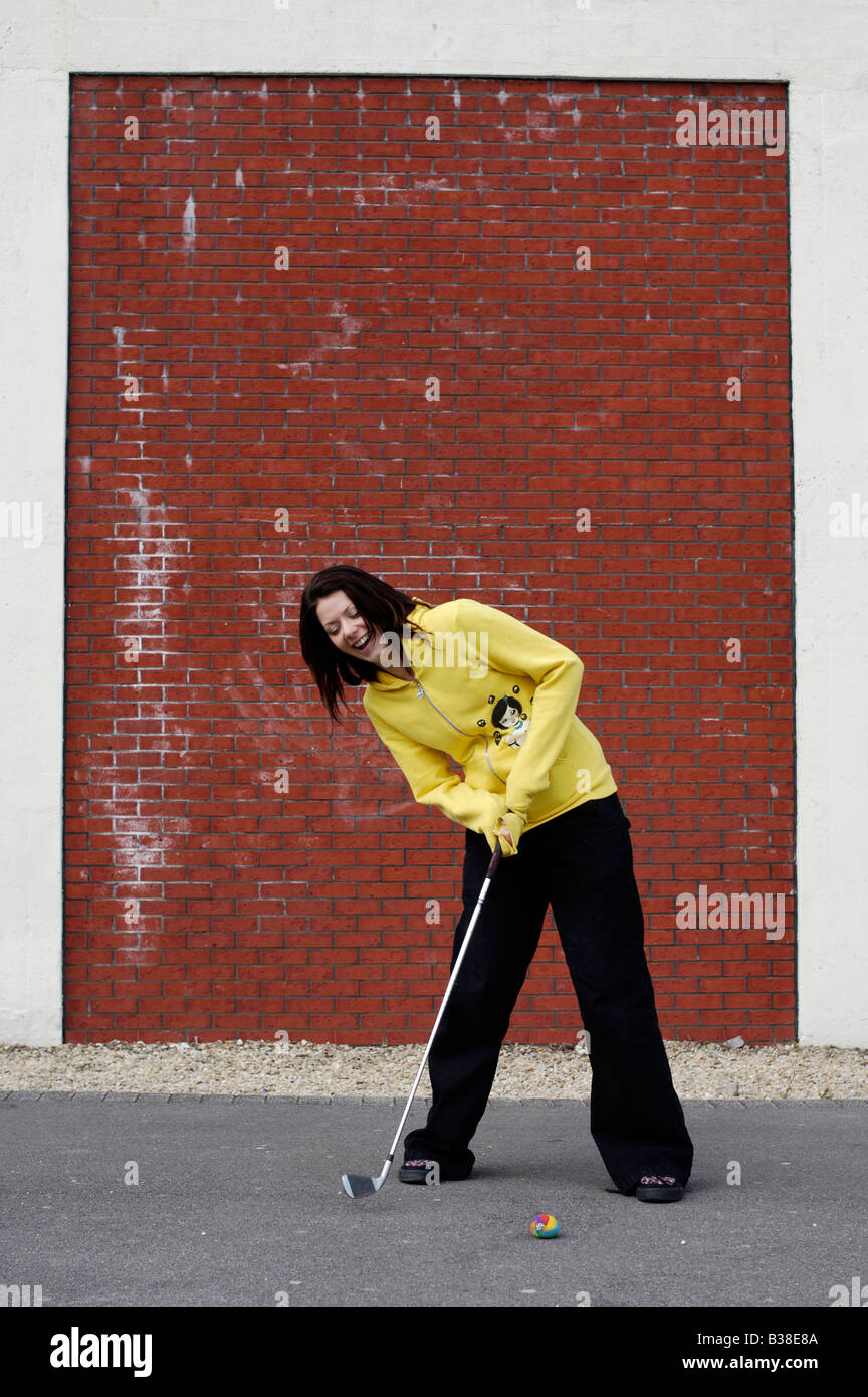 A young woman playing urban golf in the city Stock Photo - Alamy