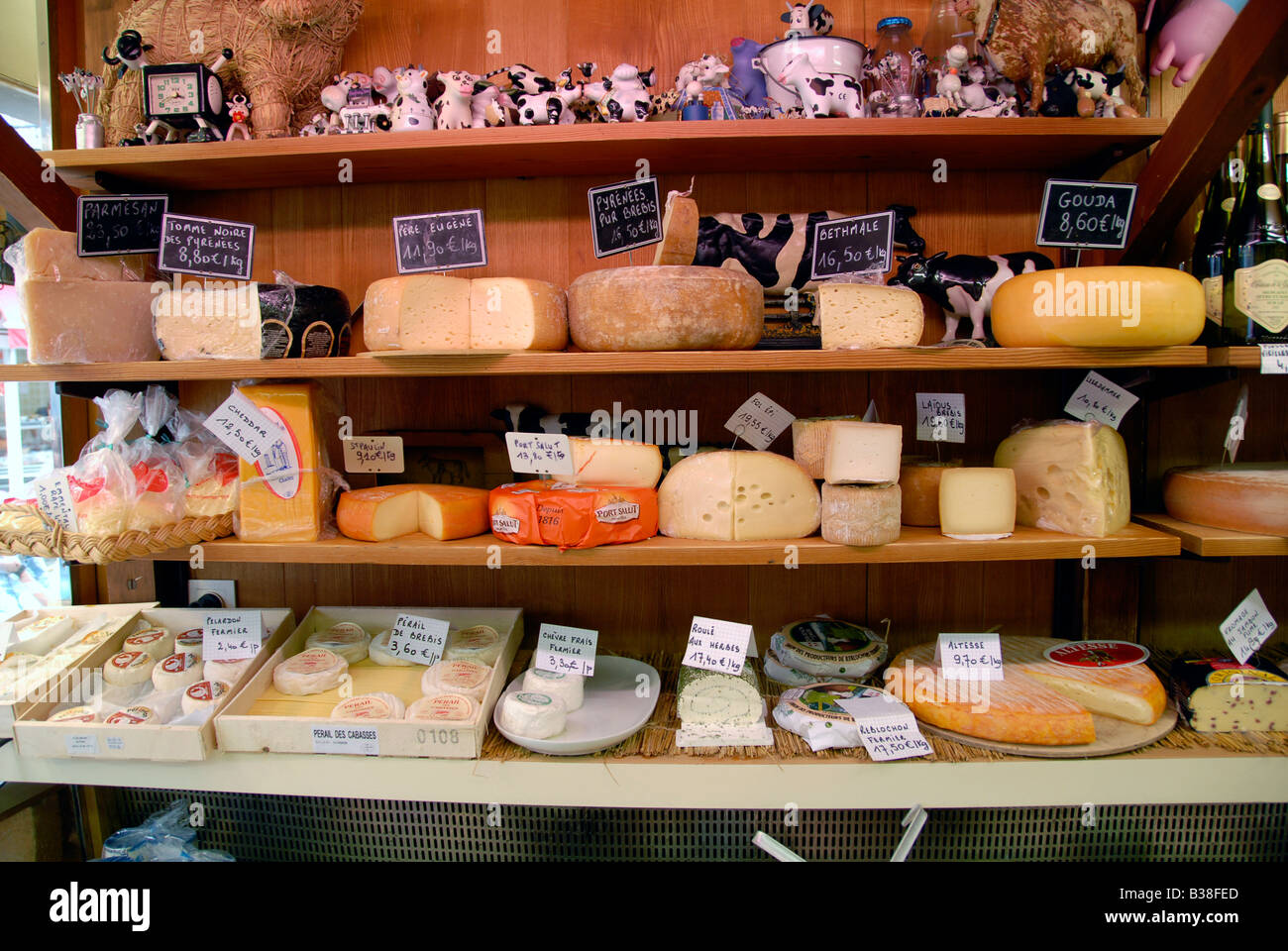Range of French traditional cheeses on an open display in a fromagerie ...