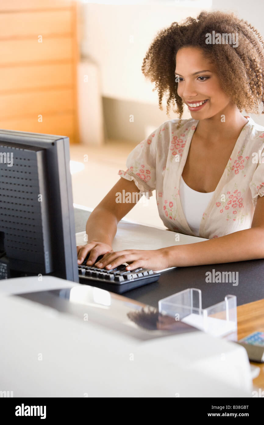 African businesswoman typing on computer Stock Photo - Alamy