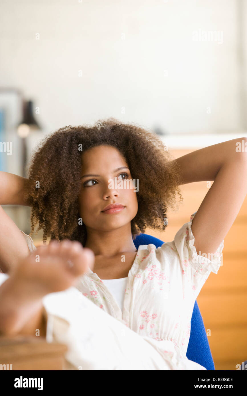 African woman with feet up on desk Stock Photo - Alamy