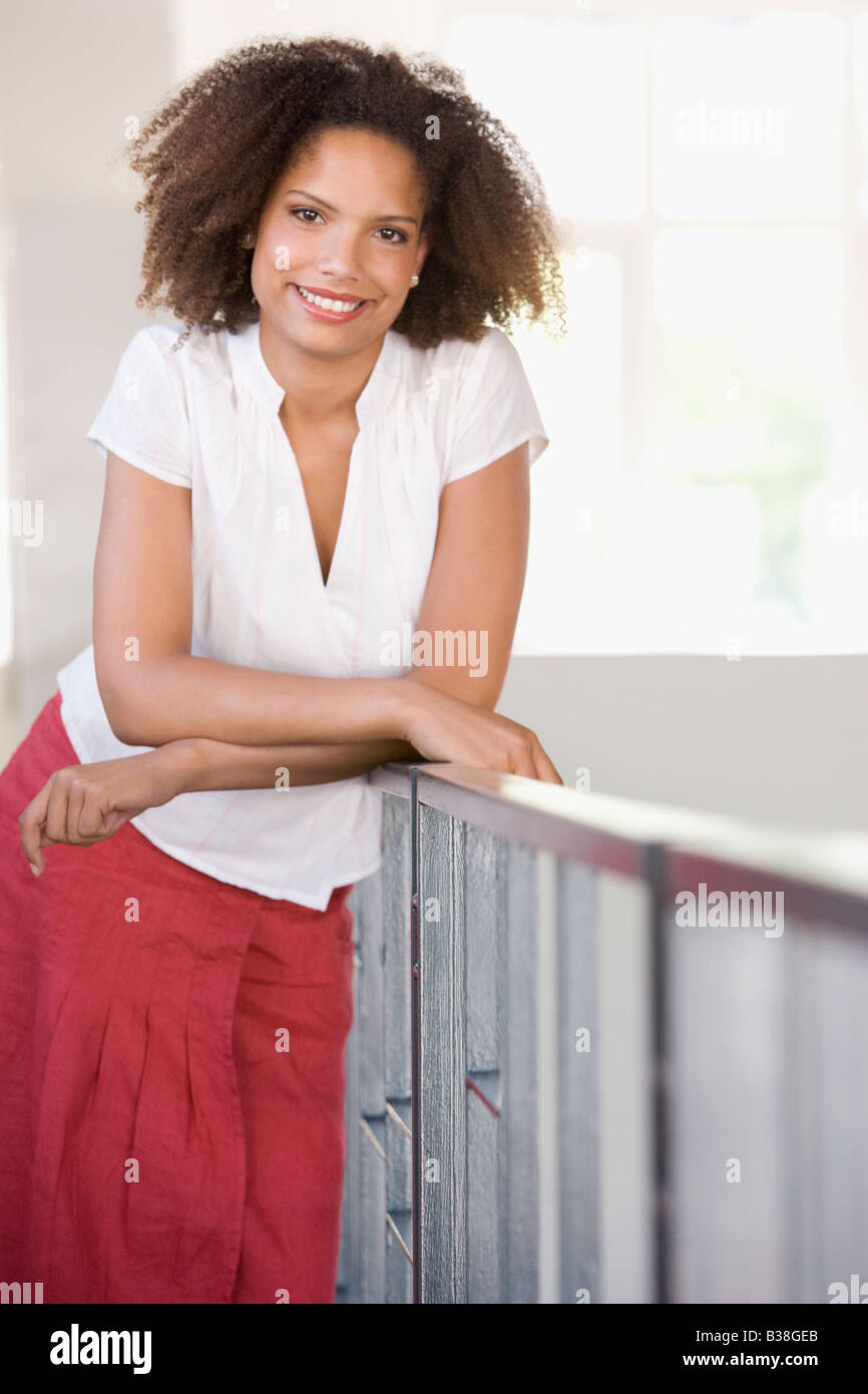 African woman leaning on railing Stock Photo - Alamy