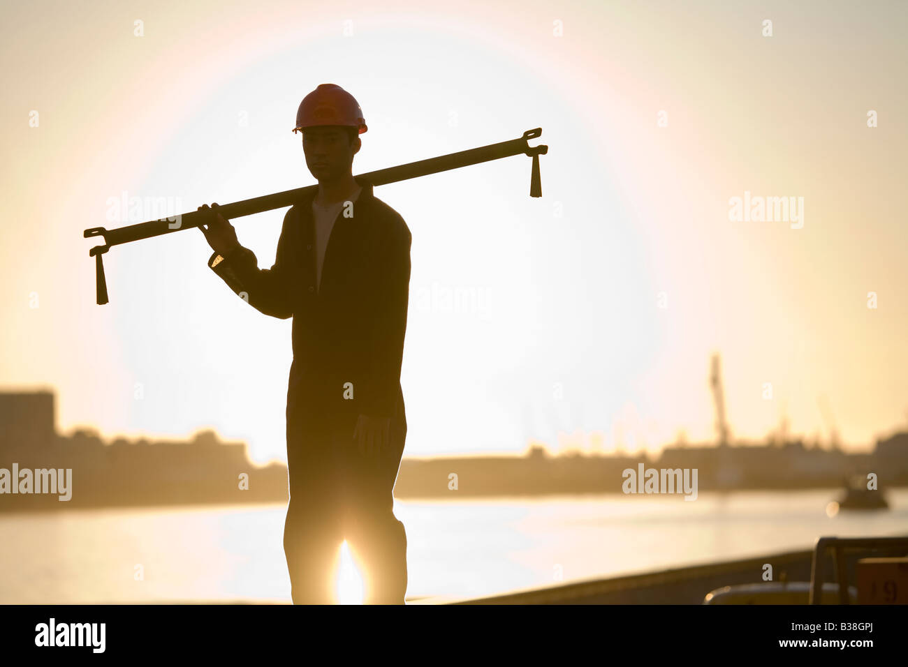 Construction worker carrying pipe hi-res stock photography and images ...