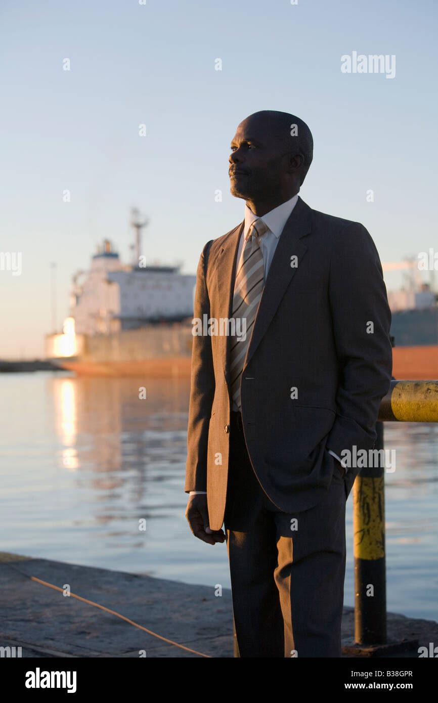 African American businessman on commercial pier Stock Photo - Alamy