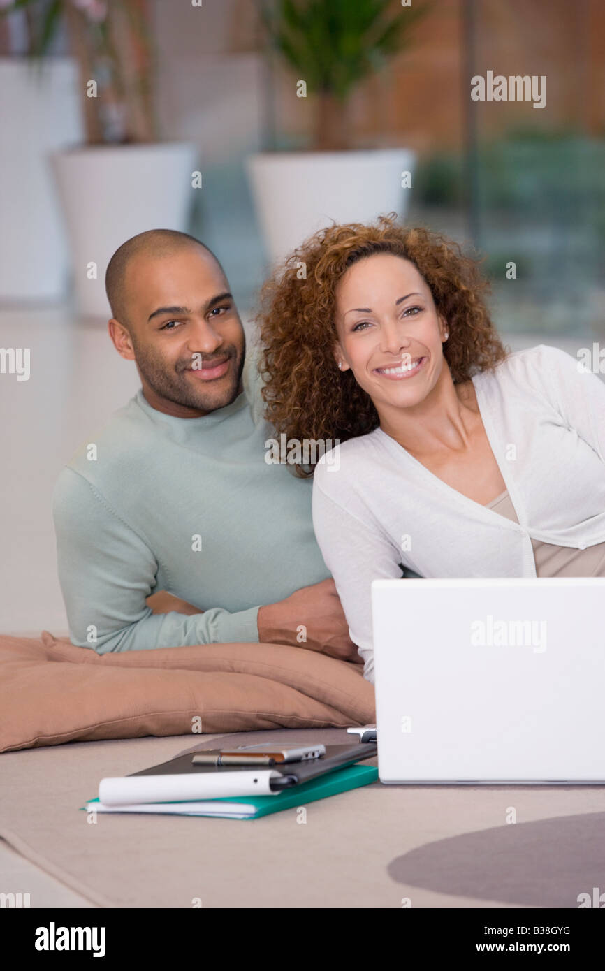 African couple working on floor Stock Photo - Alamy