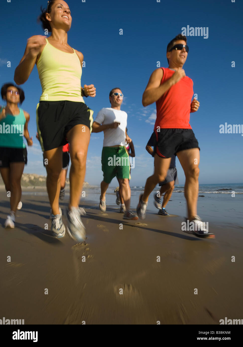 Multi-ethnic runners racing at beach Stock Photo - Alamy