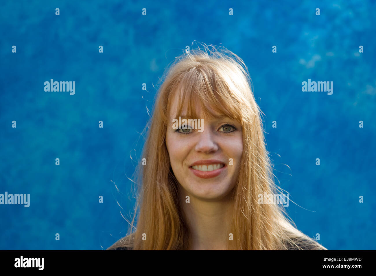 Red haired woman smiling Stock Photo - Alamy