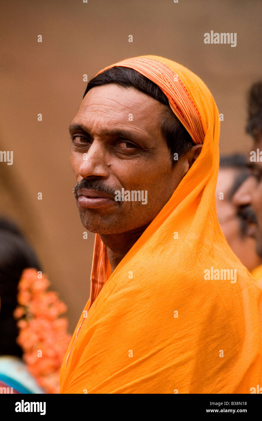A Jain pligrim wears orange robes during the Mahamastakabisheka in ...