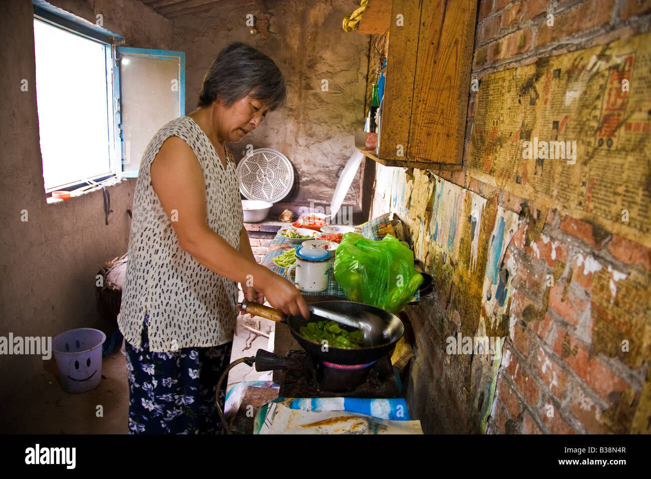 Modern peasant woman cooking in Datianzhuang village, Juyang County ...