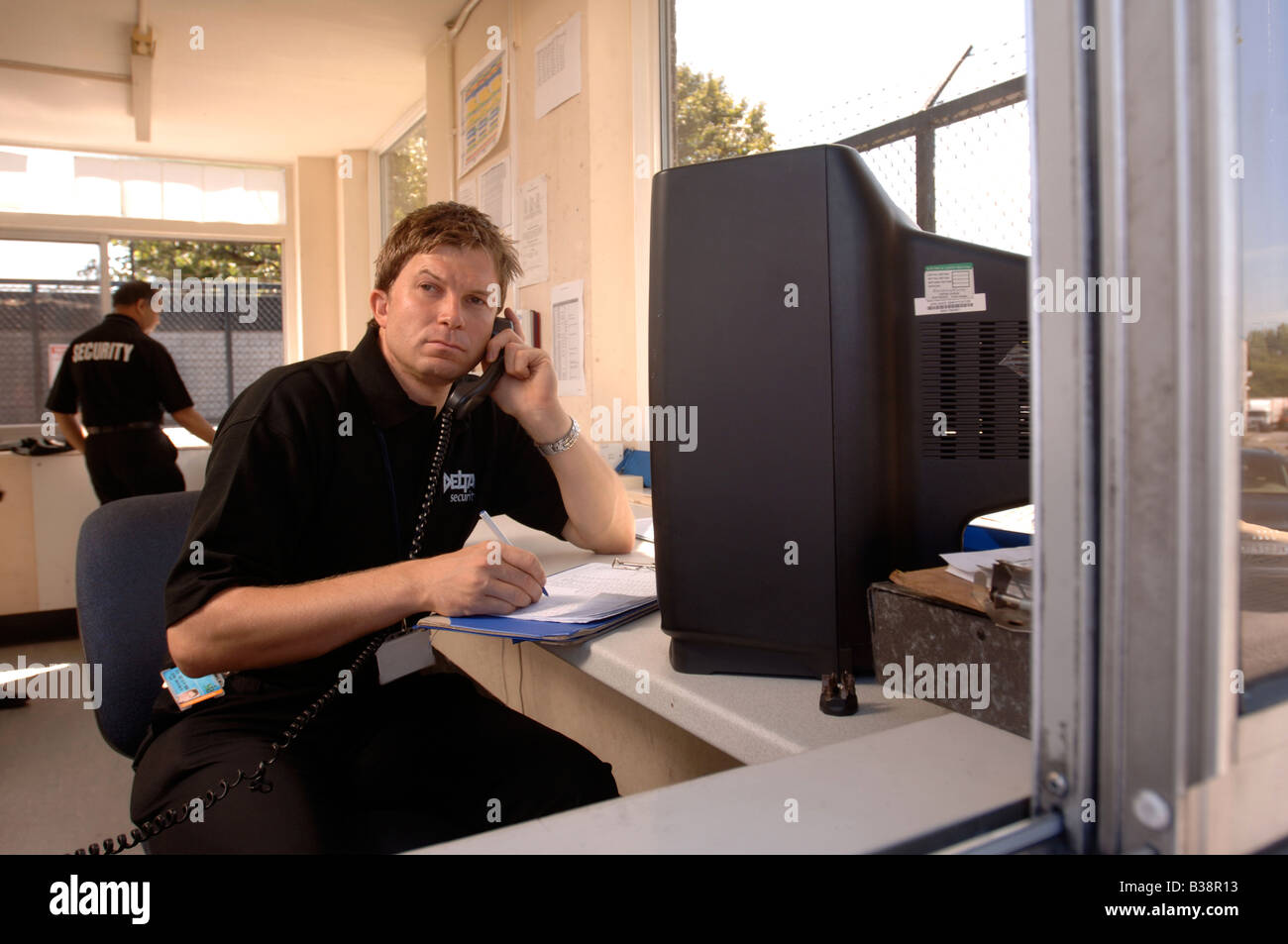 A SECURITY GUARD CHECKS CCTV IMAGES AT A CHECKPOINT UK Stock Photo - Alamy