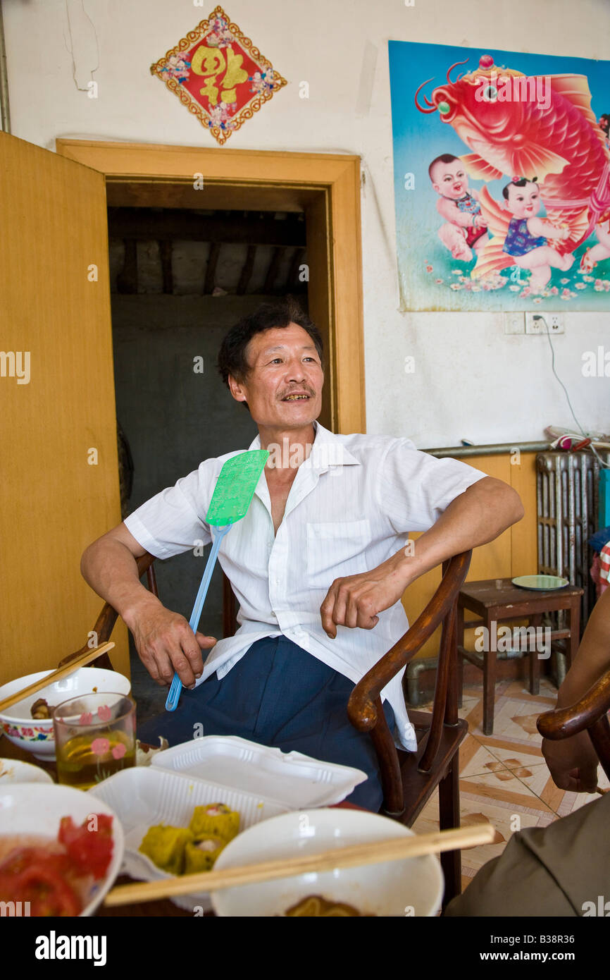Modern peasant man at table in Datianzhuang village, Juyang County ...