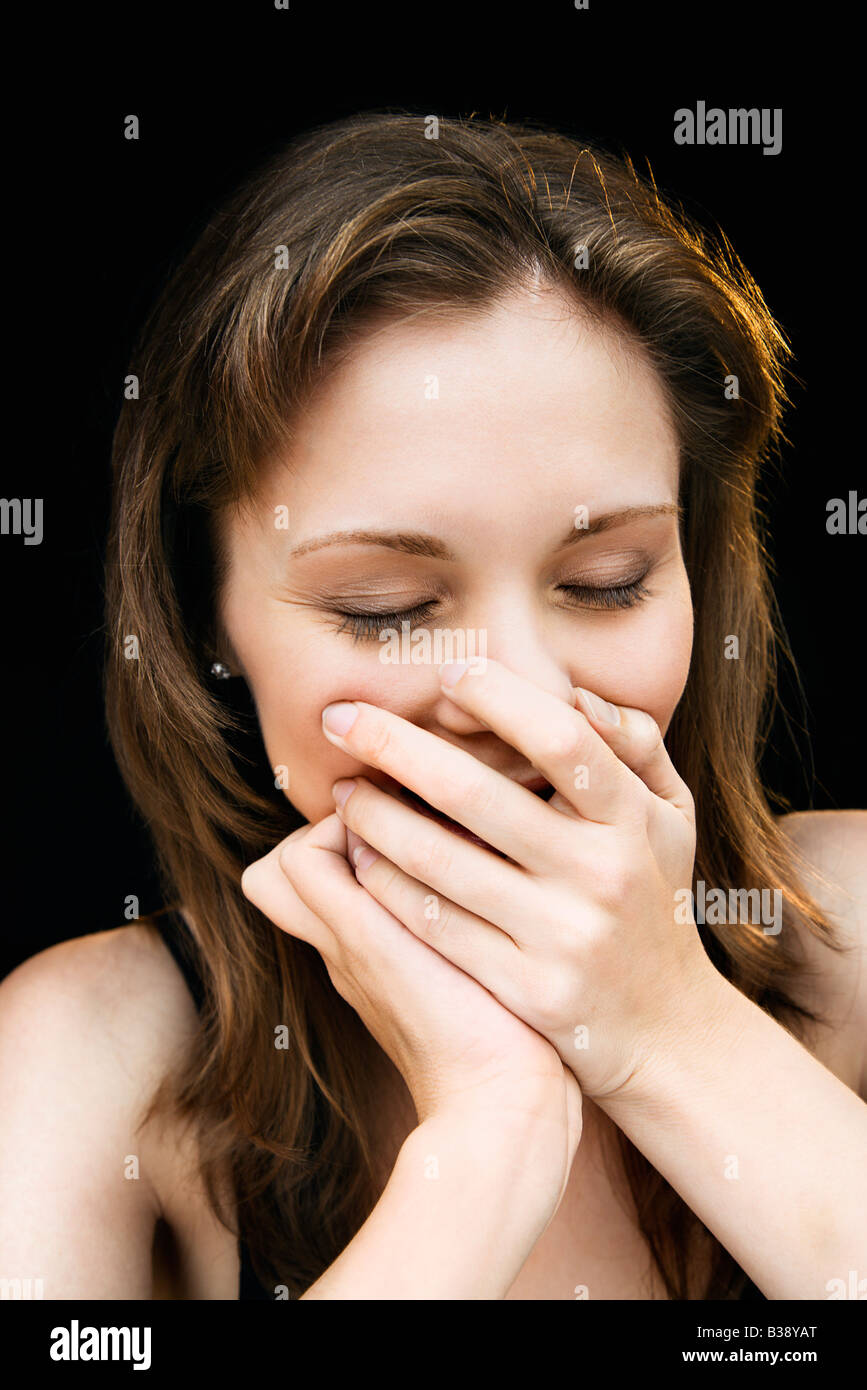 Woman laughing hand over mouth hi-res stock photography and images - Alamy