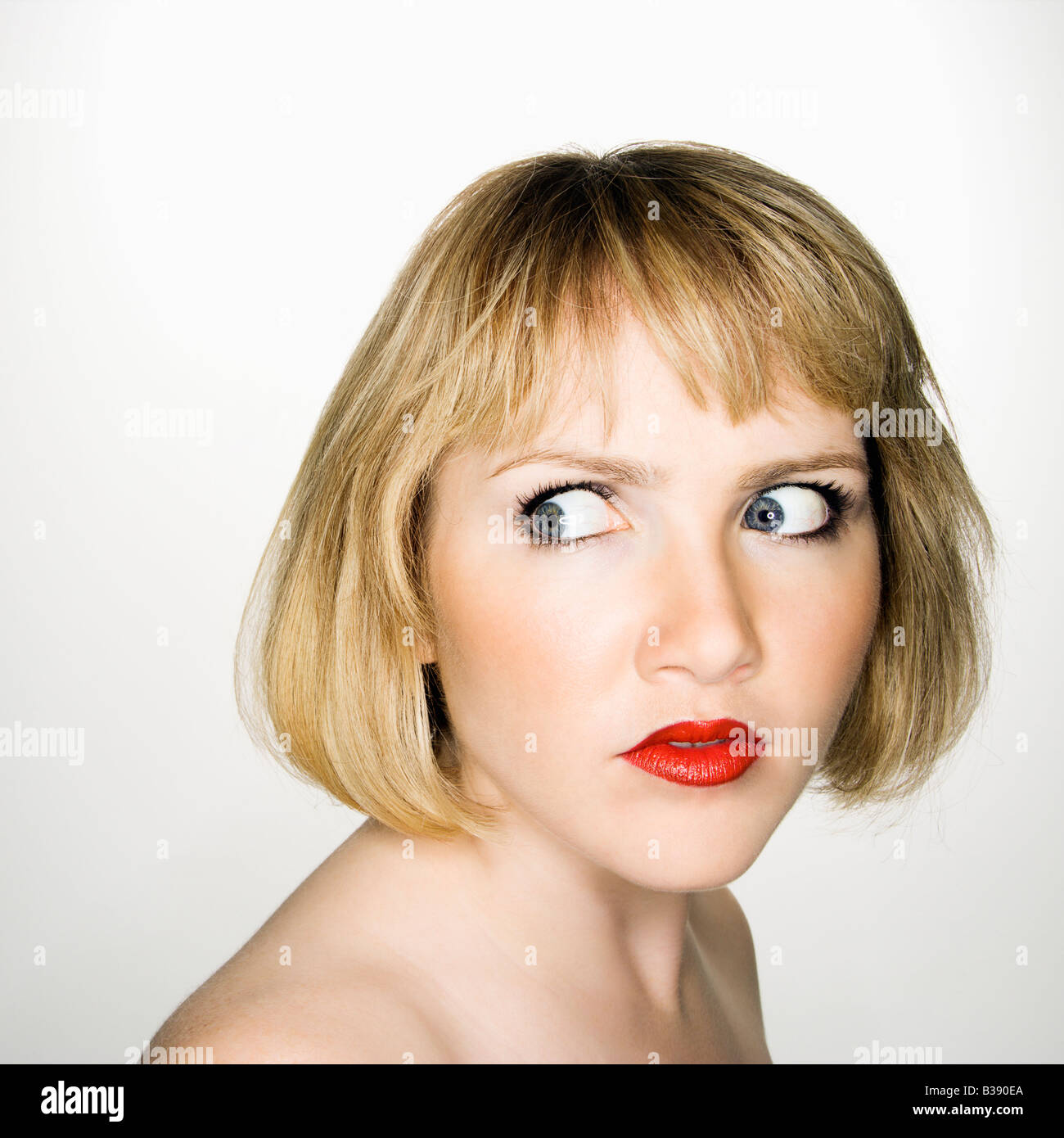 Portrait of young blonde caucasian woman who has suspicious expression ...