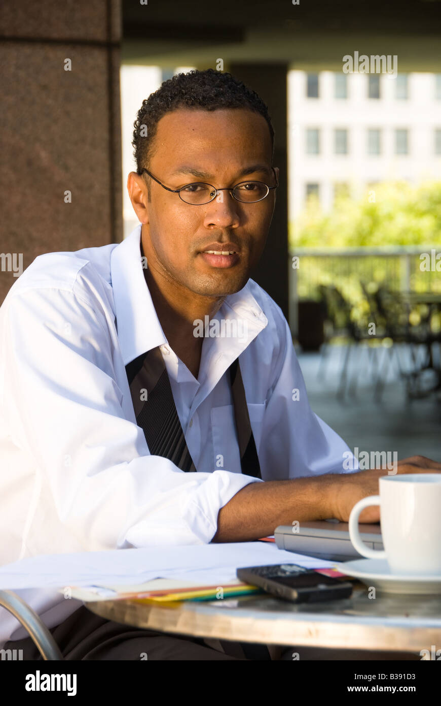 An executive engineer conducting work during his lunch hour Stock Photo ...