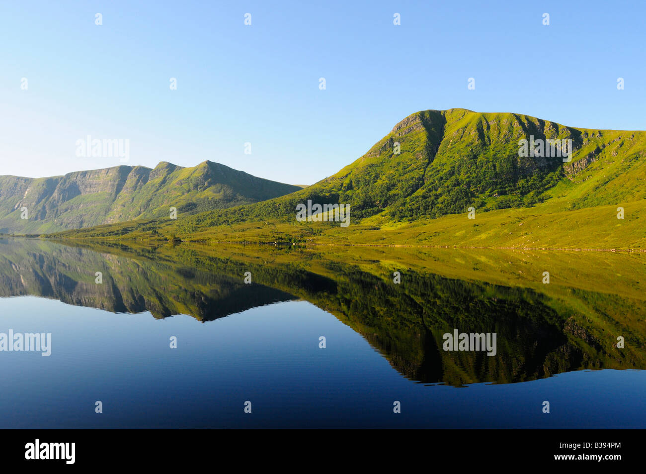 Green mountain reflecting in hi-res stock photography and images - Alamy