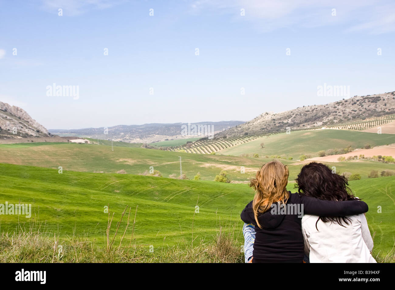 Two young friends looking rural landscape Stock Photo - Alamy