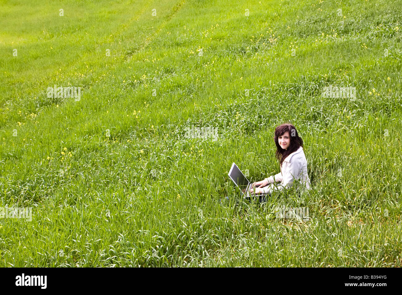 Young woman connected to the internet in a meadow Stock Photo - Alamy