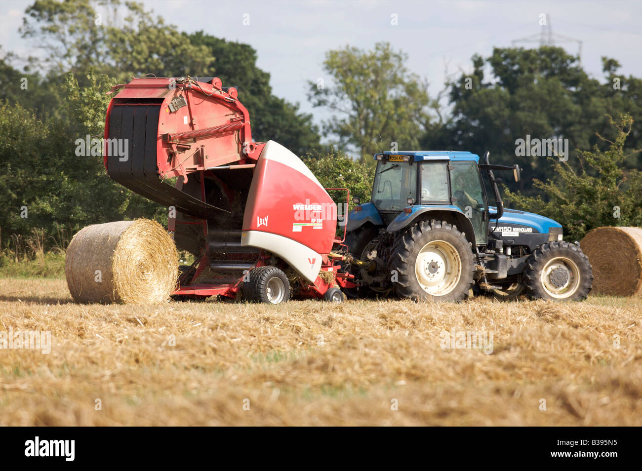 New Holland Tractor Baling Wheat Straw Stock Photo - Alamy