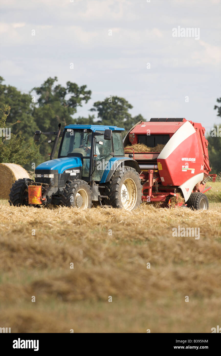 New Holland Tractor Baling Wheat Straw Stock Photo - Alamy
