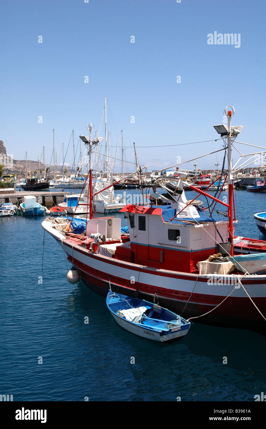 Red fishing boat moored in a port Stock Photo - Alamy
