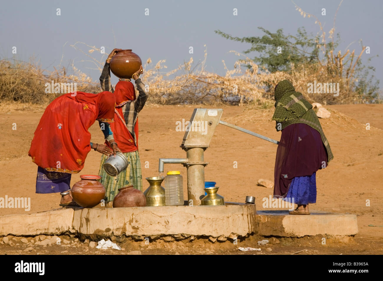 Women by water pump hi-res stock photography and images - Alamy