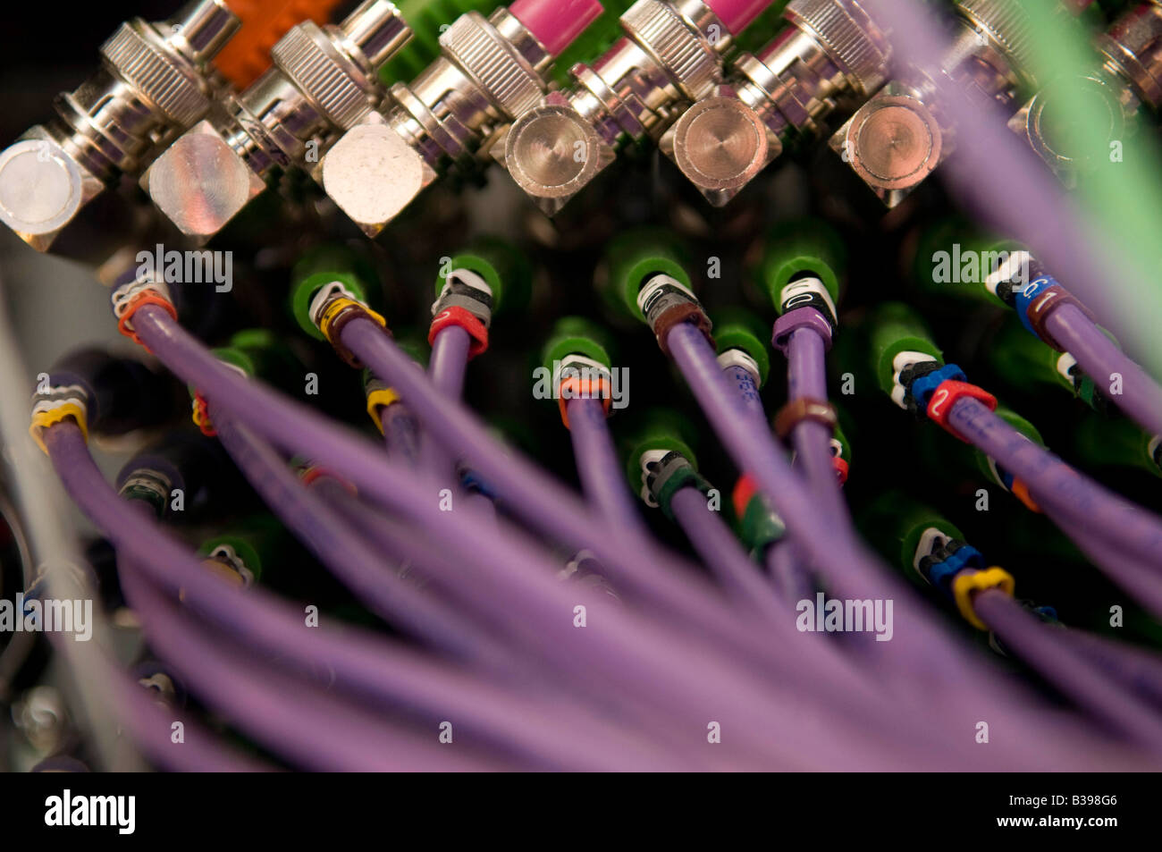 video cables connected to the connector panel of a video router ...