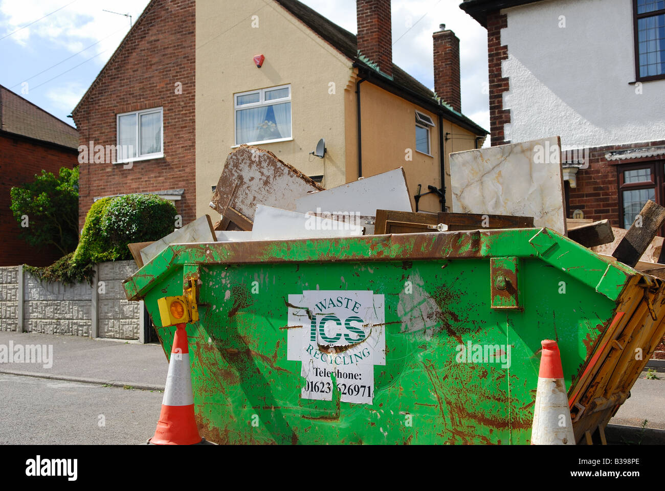 Skip builders rubble Stock Photo - Alamy