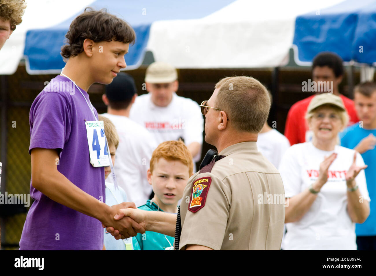 Police officer congratulating winning athlete. Special Olympics U of M ...
