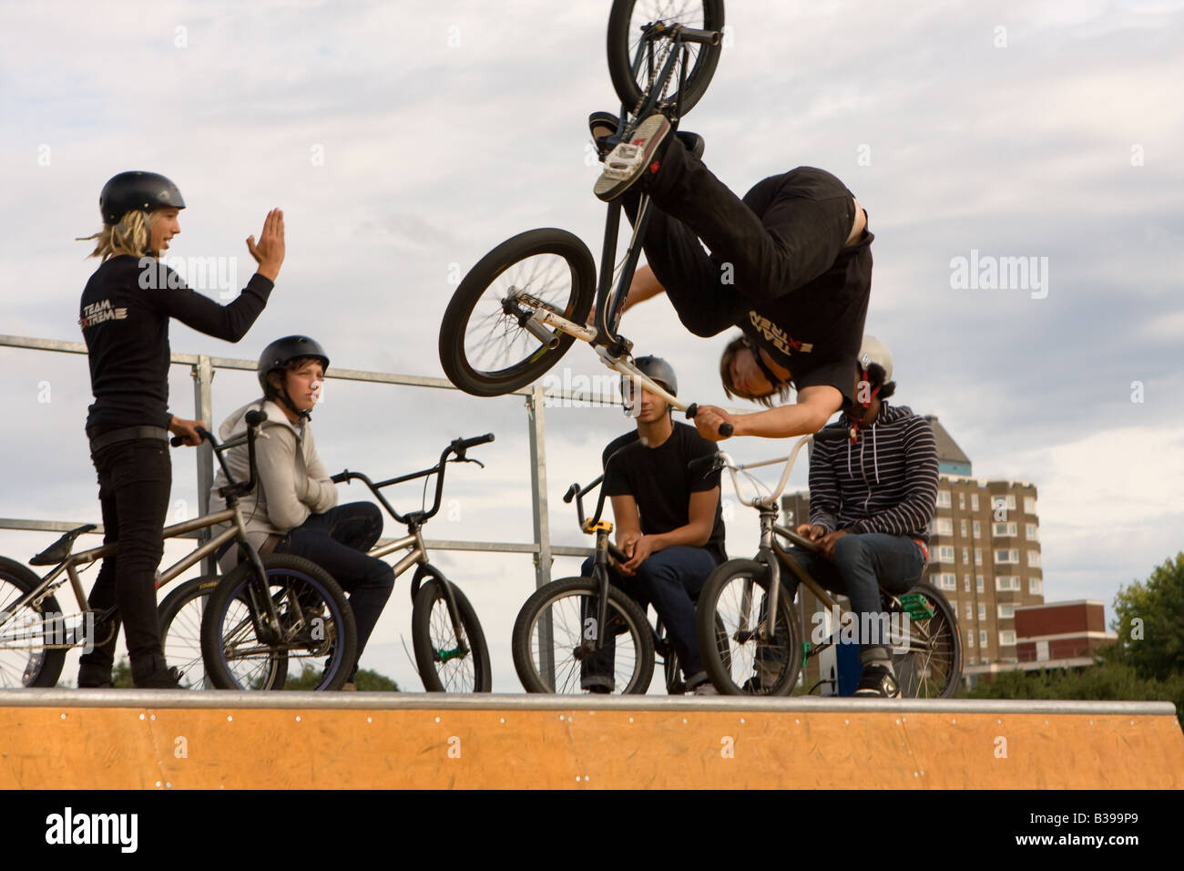 A member of Team Extreme stunt team performs a trick on a half pipe ...