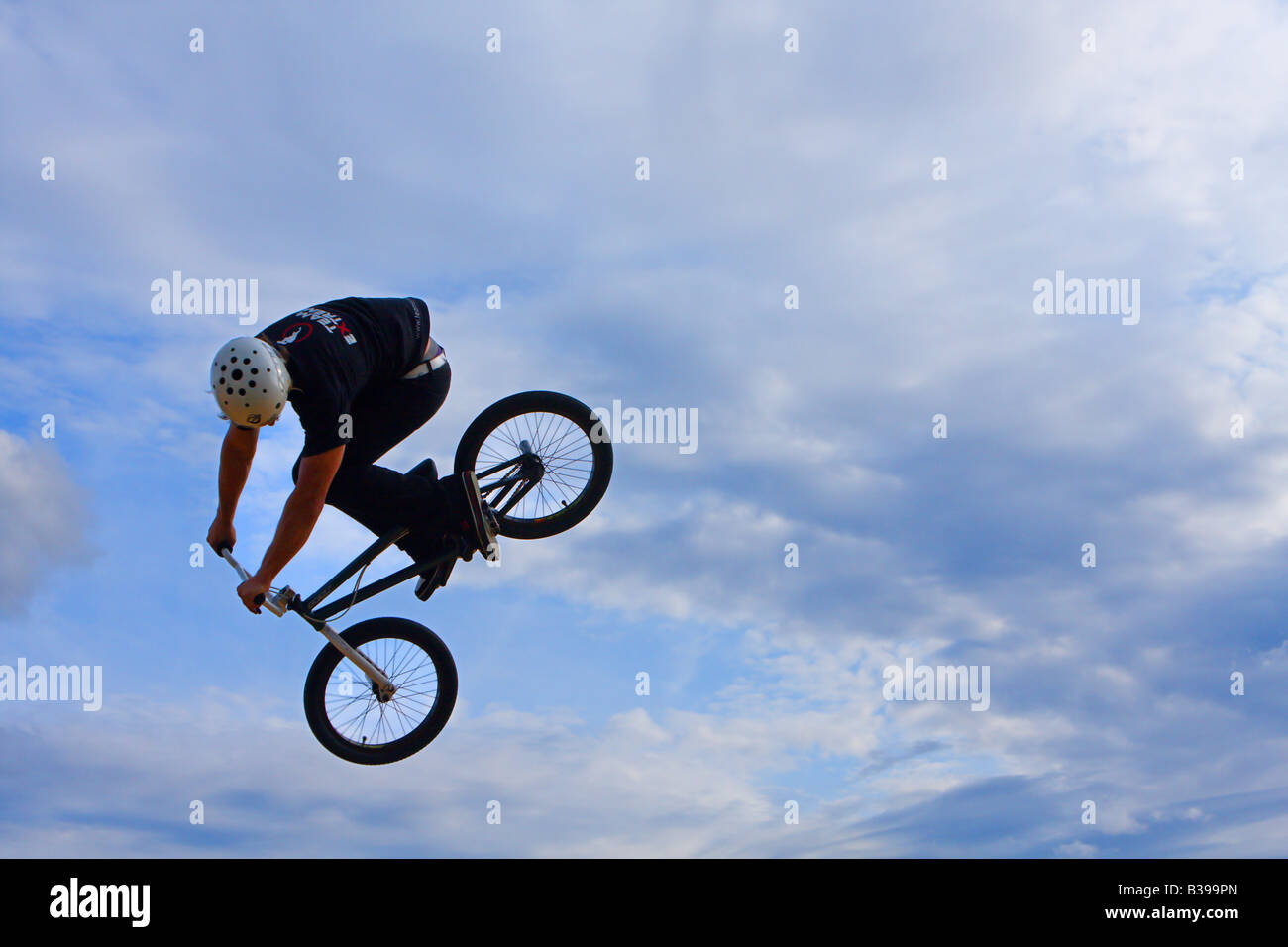 Team Extreme member performing BMX trick in the air on half-pipe Stock ...