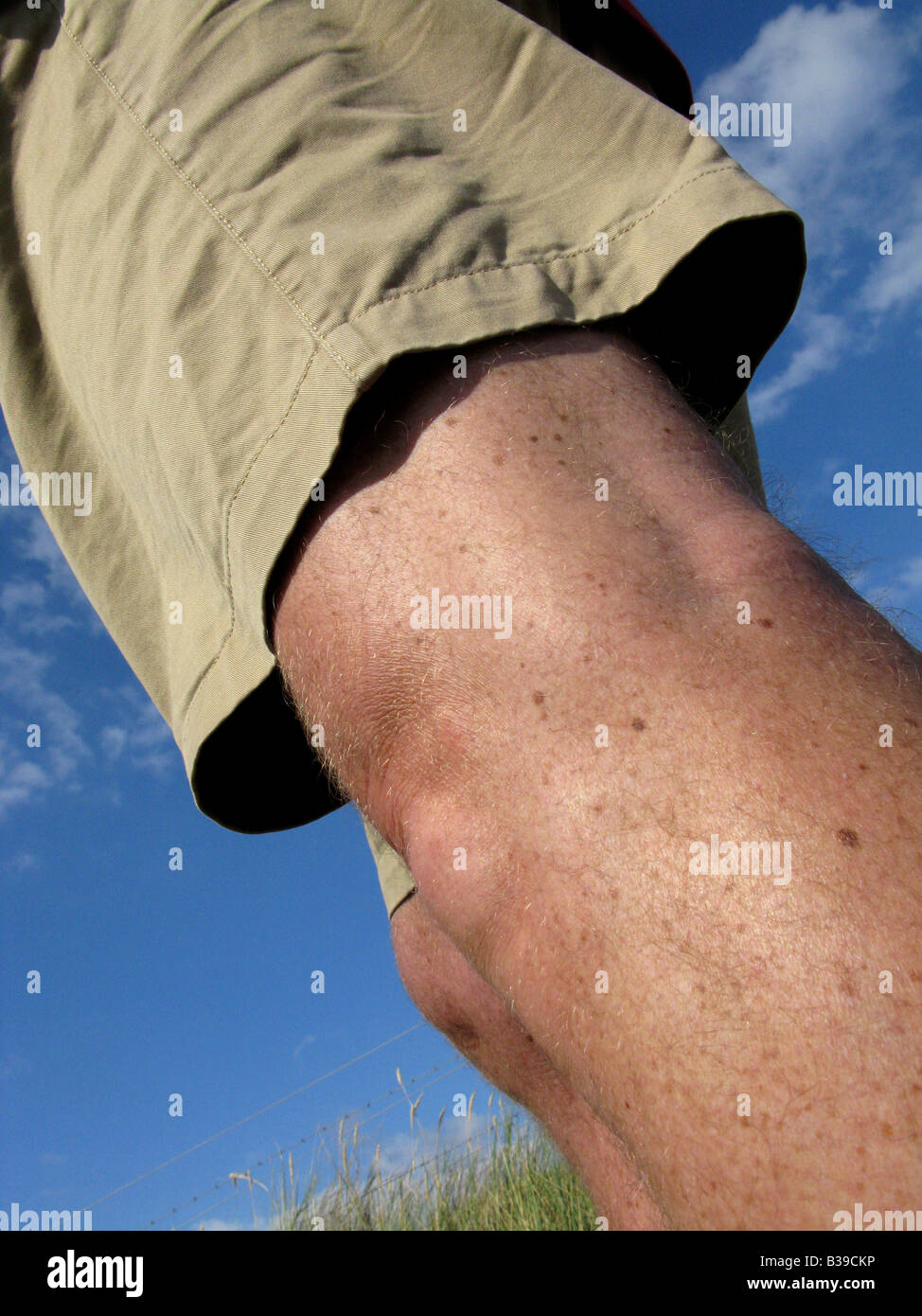 Man's legs on the beach England Stock Photo - Alamy