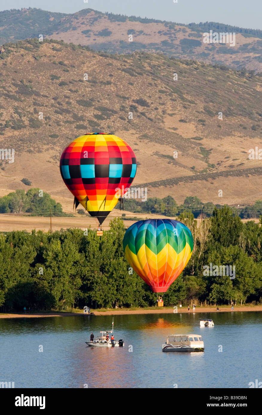Boats and spectators enjoy a mass ascension of hot air balloons at the ...