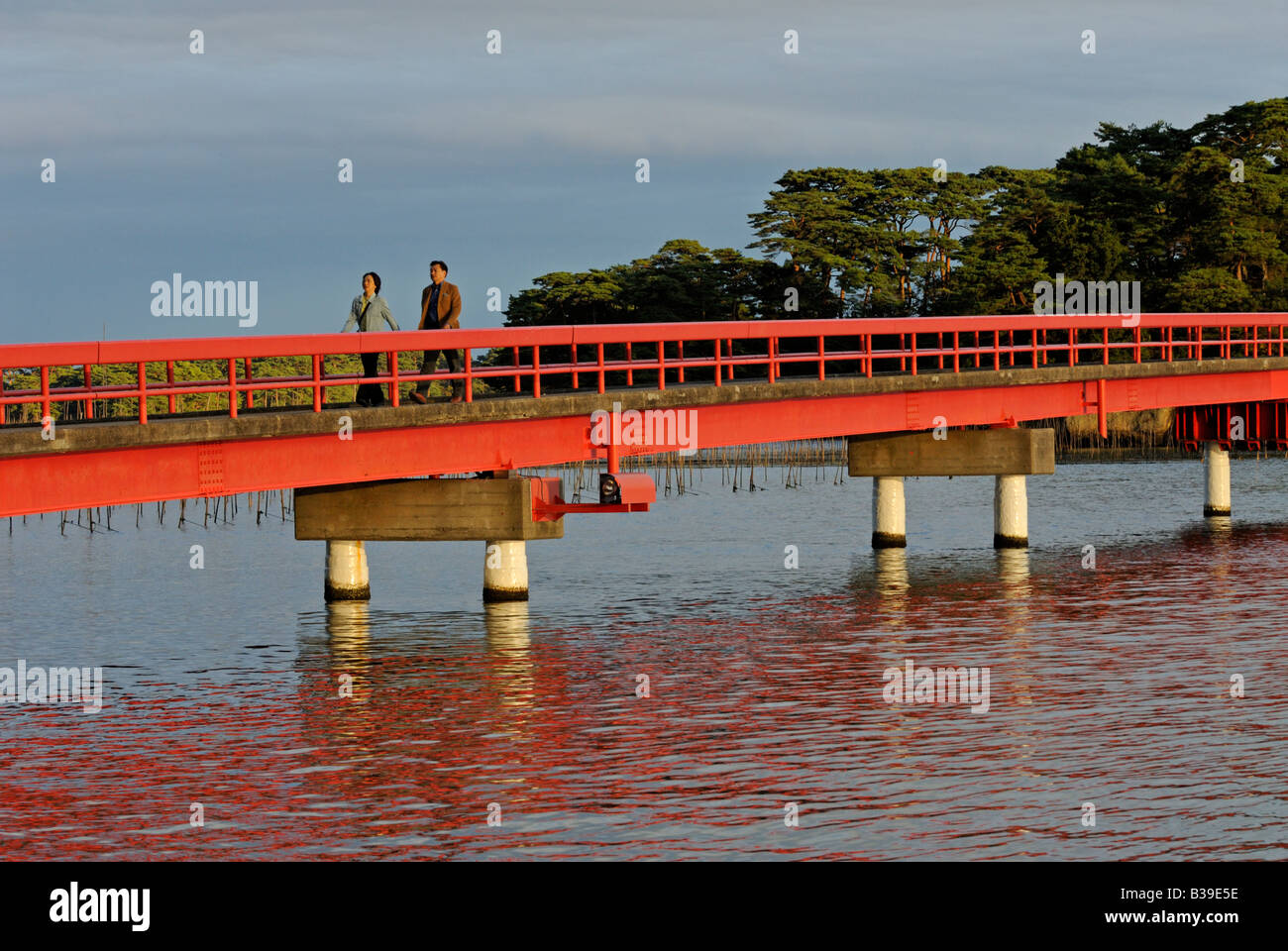 Two Japanese tourists walking across red bridge Matsushima Japan Stock ...