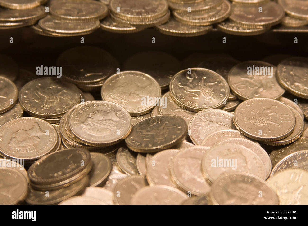 Coins in an arcade gaming machine Stock Photo - Alamy