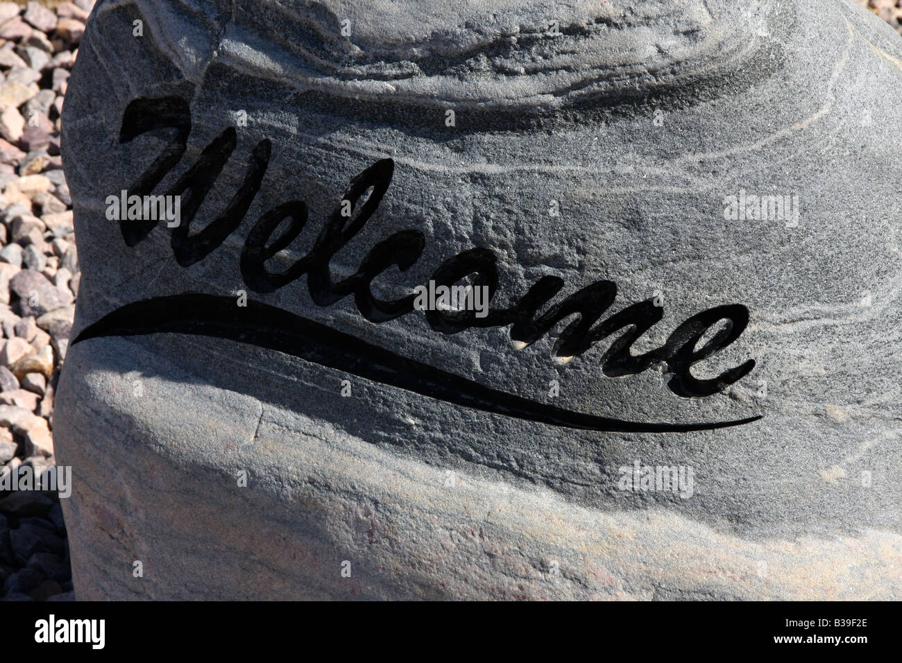 Word welcome carved into rock Stock Photo - Alamy