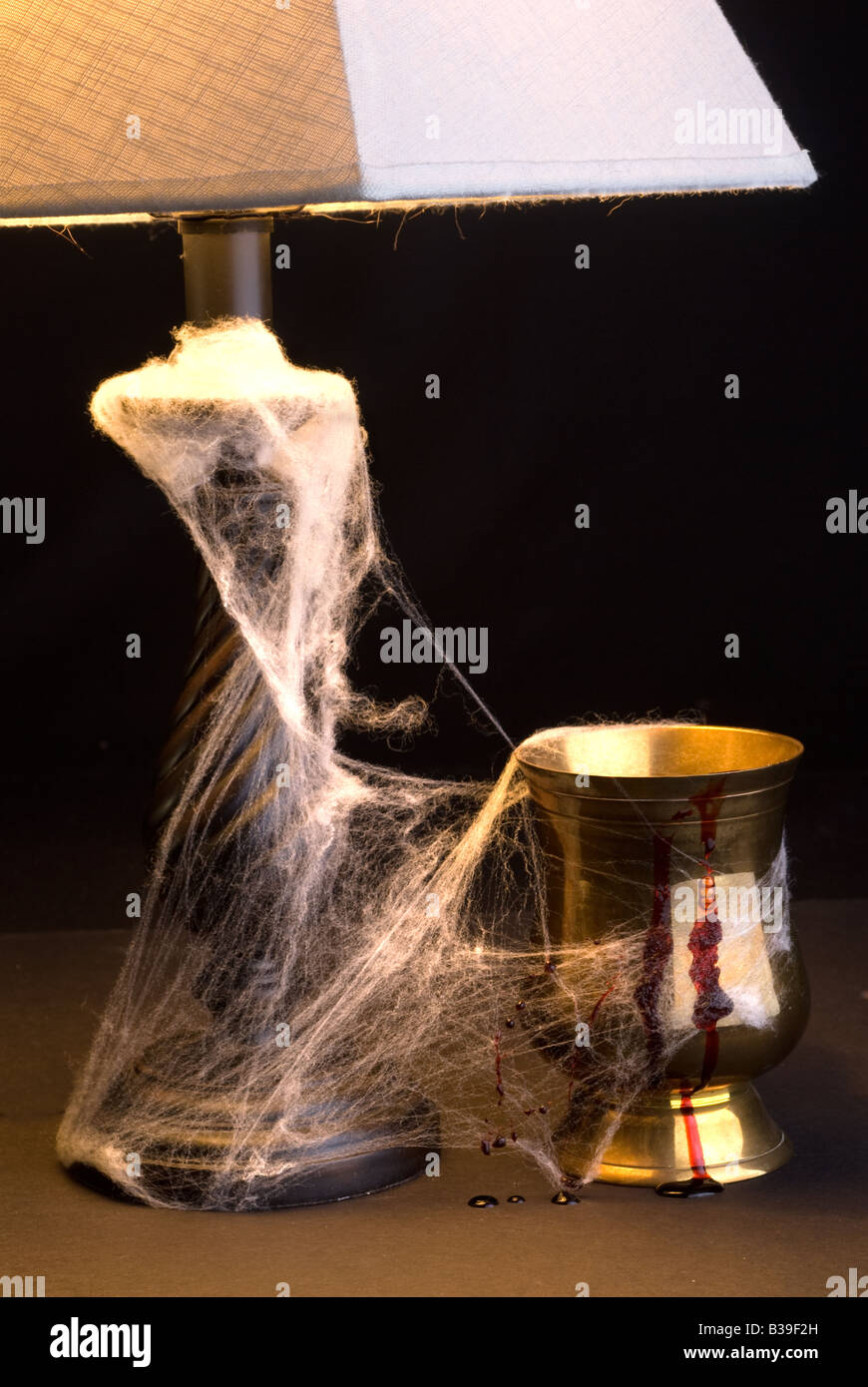 Light and goblet in cobwebs with blood on the goblet Stock Photo - Alamy