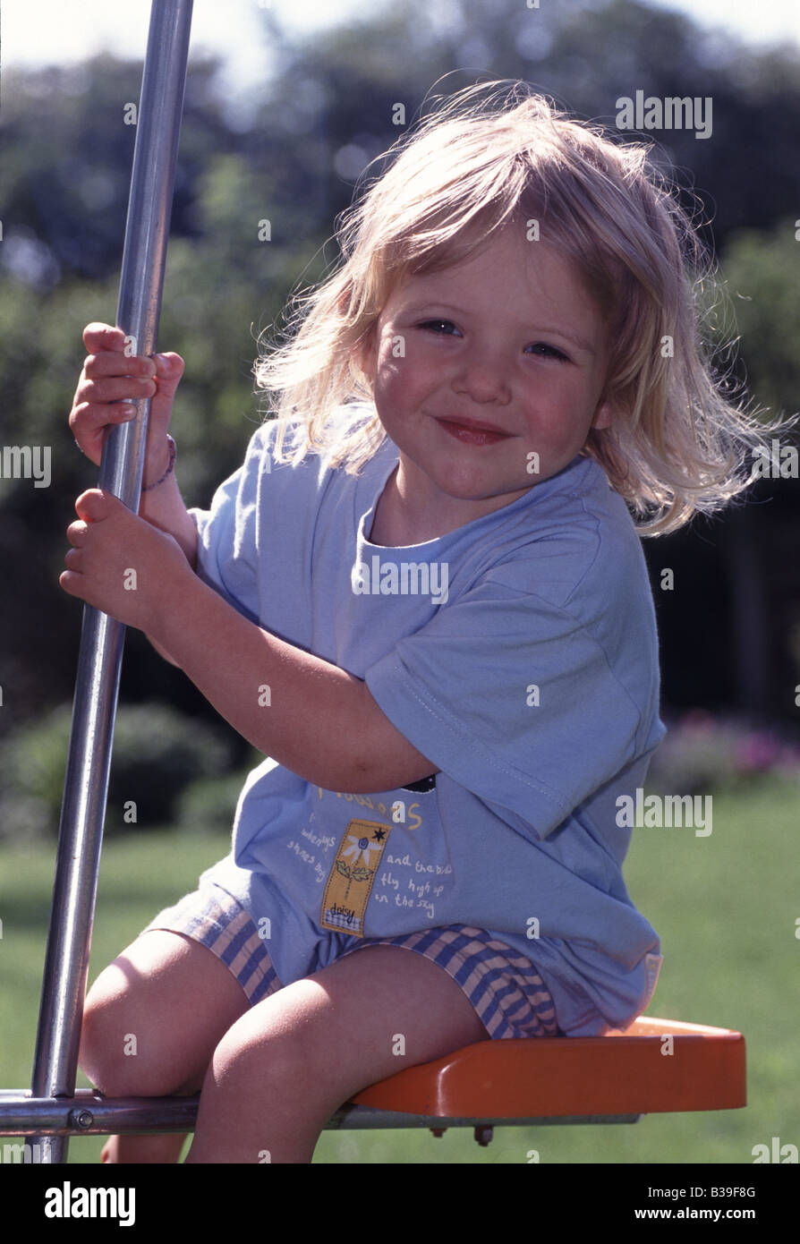 Toddler playing on a garden swing Stock Photo - Alamy