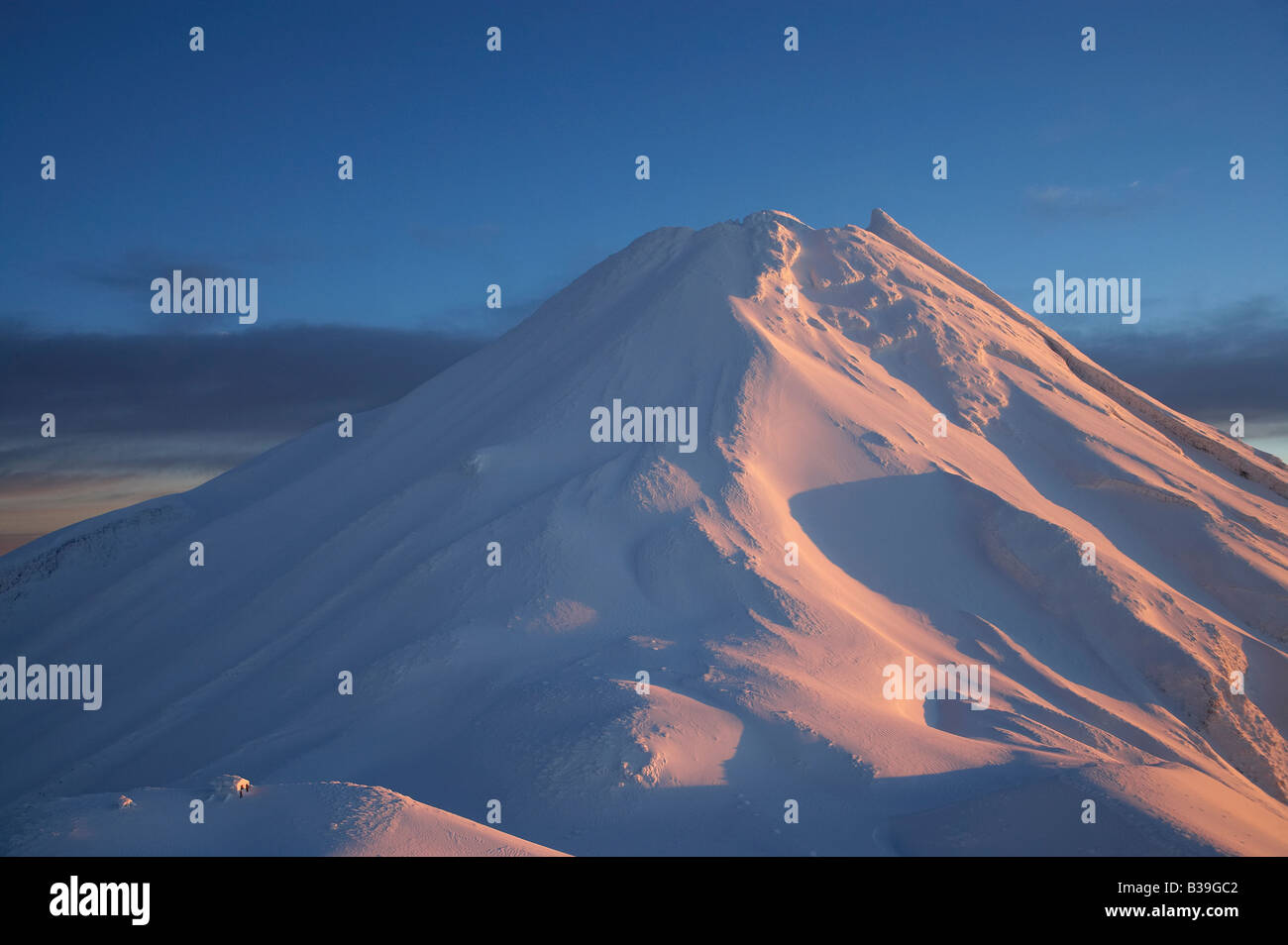 Climbers at Syme Hut Fanthams Peak and Alpenglow at Dawn on Mt Taranaki ...