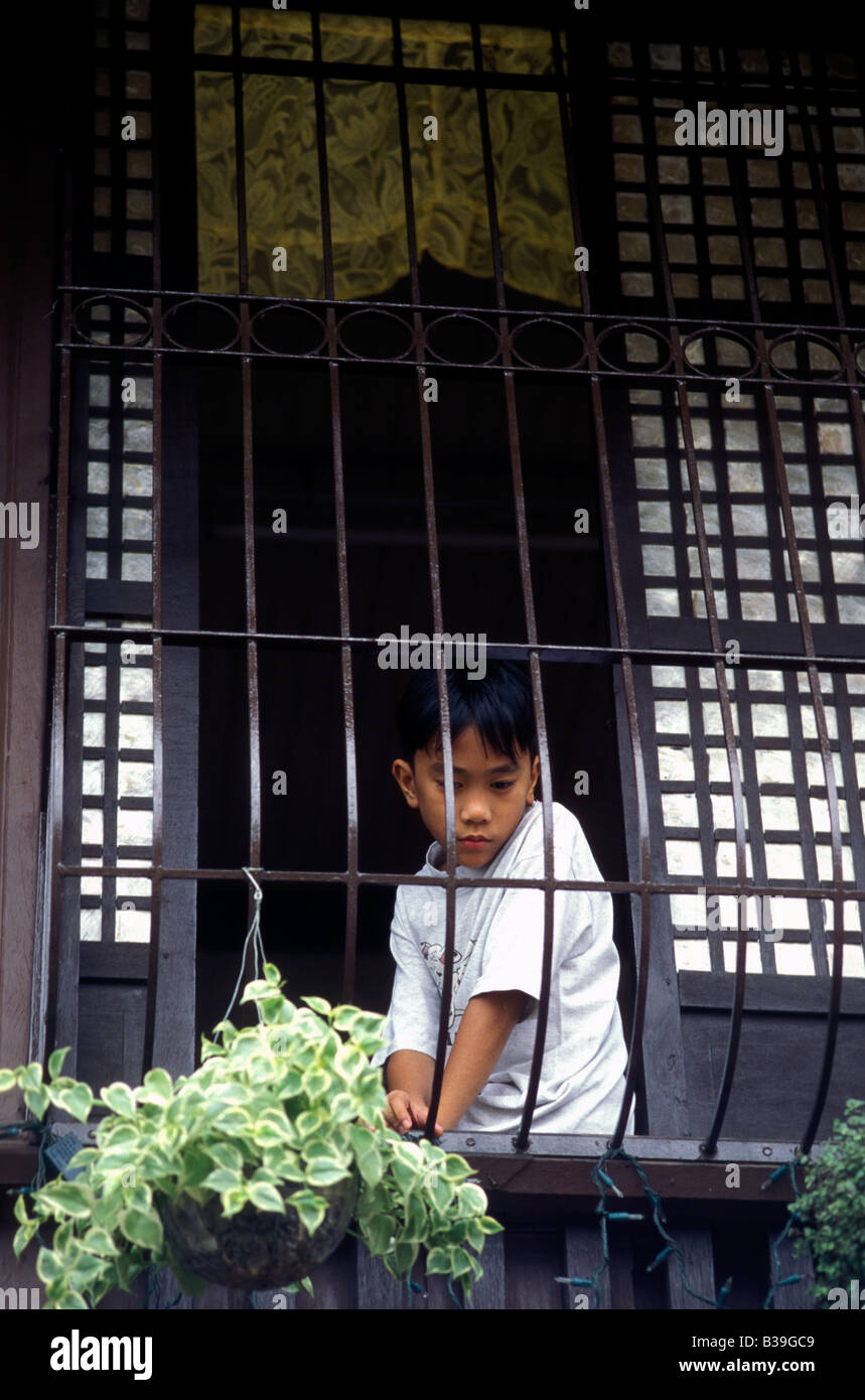 boy in ancestral house window taal luzon philippines Stock Photo - Alamy