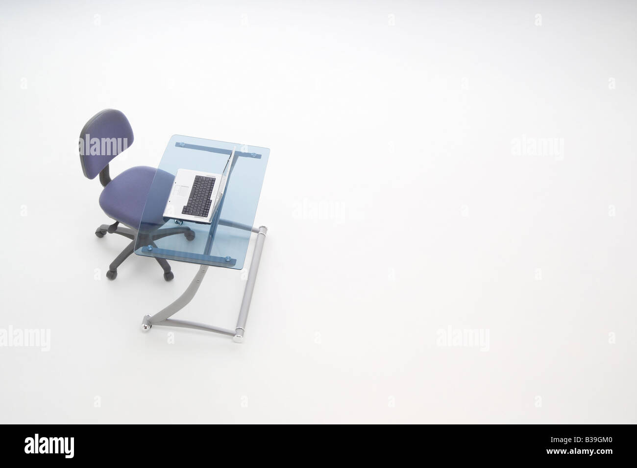 Laptop computer on desk and chair Stock Photo - Alamy