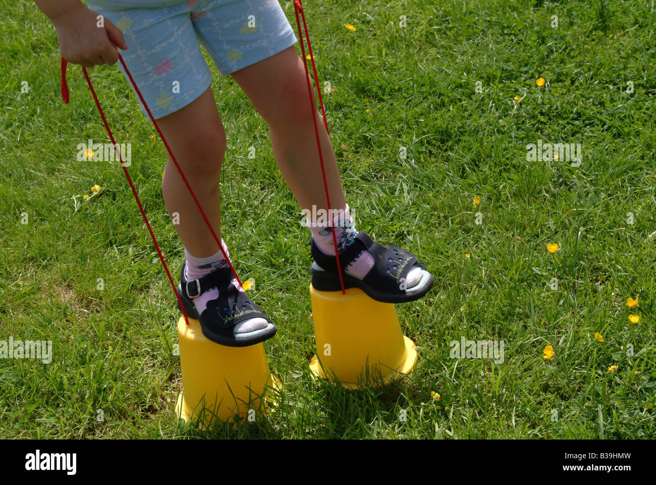 Close up of childs feet on stilts Stock Photo - Alamy