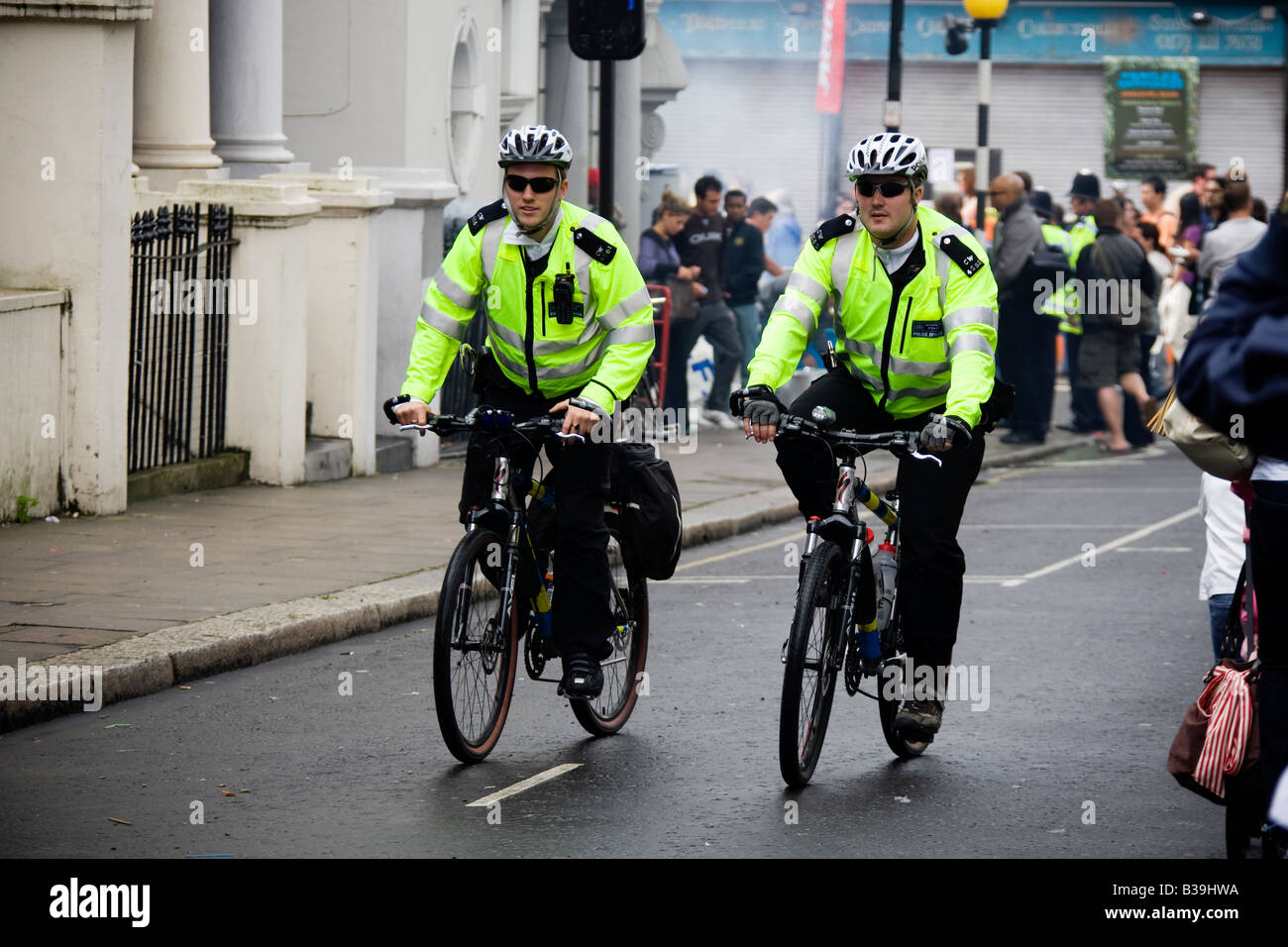 Two officers of the London Metropolitan Police Force patrol on bicycles ...